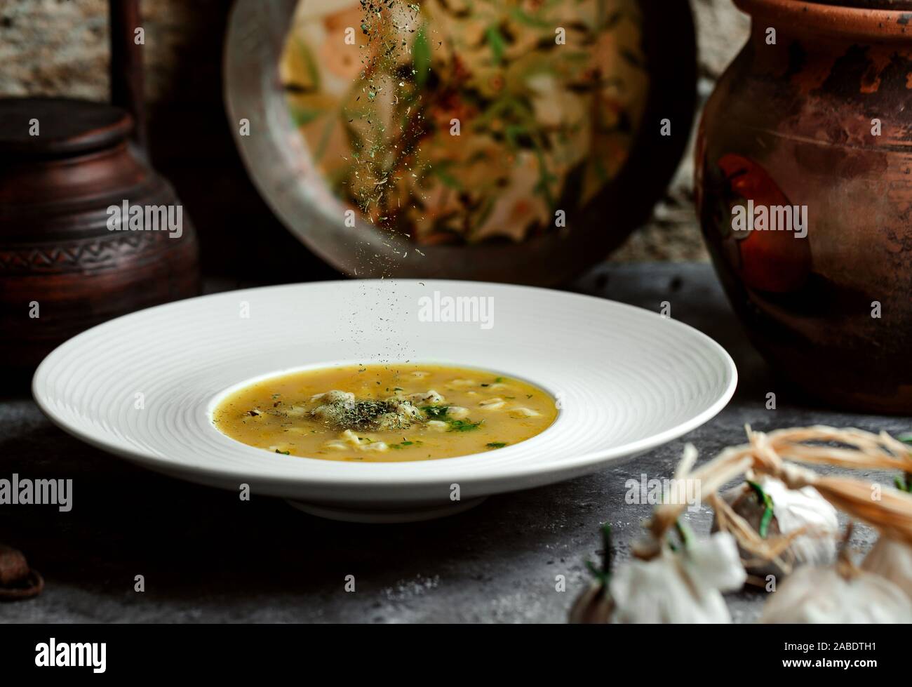 dried mint leaves sprinkled into dushbara dumpling soup Stock Photo - Alamy
