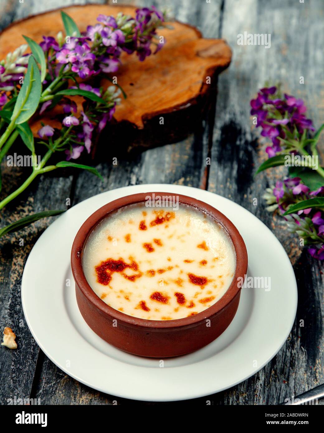 turkish milk pudding sutlach desert in pottery bowl Stock Photo - Alamy