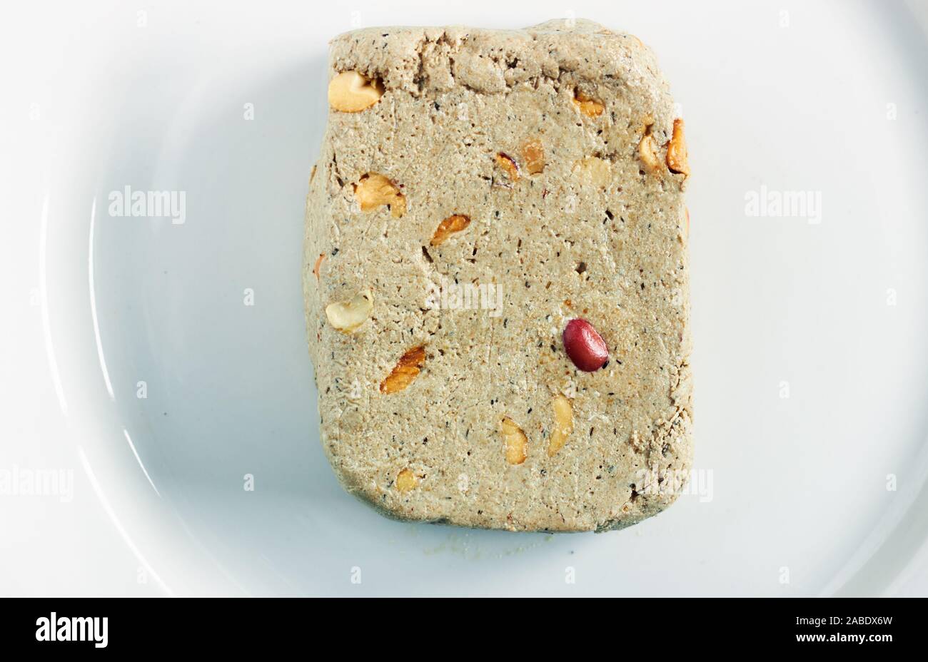 Square piece of sunflower halva sweet dessert with normal peanuts and ...