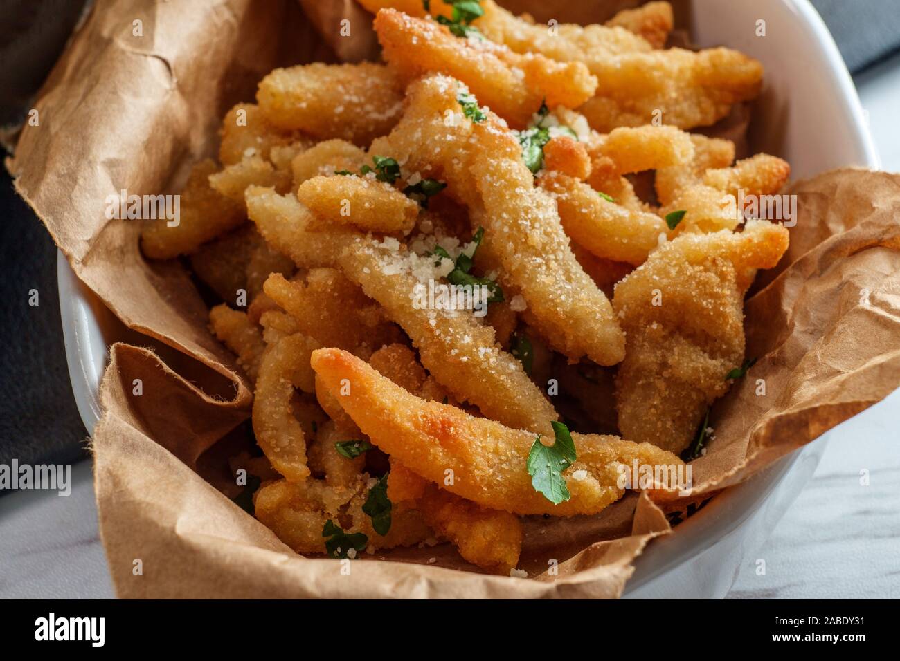 New England fried clam strips served with a bowl of tartar dipping ...