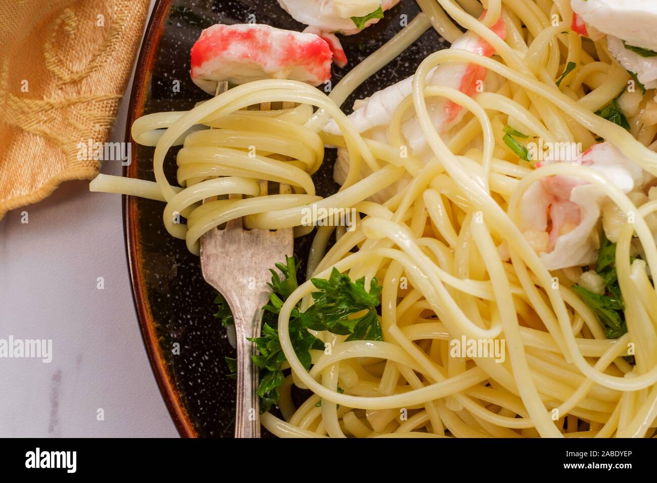 Italian crab scampi over linguine pasta with parsley garnish Stock ...