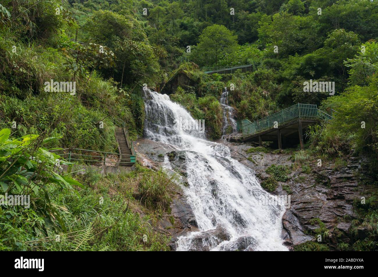 Waterfall in the forest with tourist infrastructure. Ecotourism nature ...