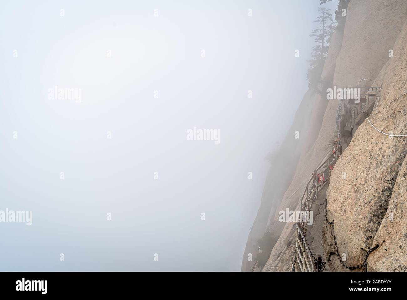 Stone steps cut on a side of a mountain rock leading to the dangerous ...