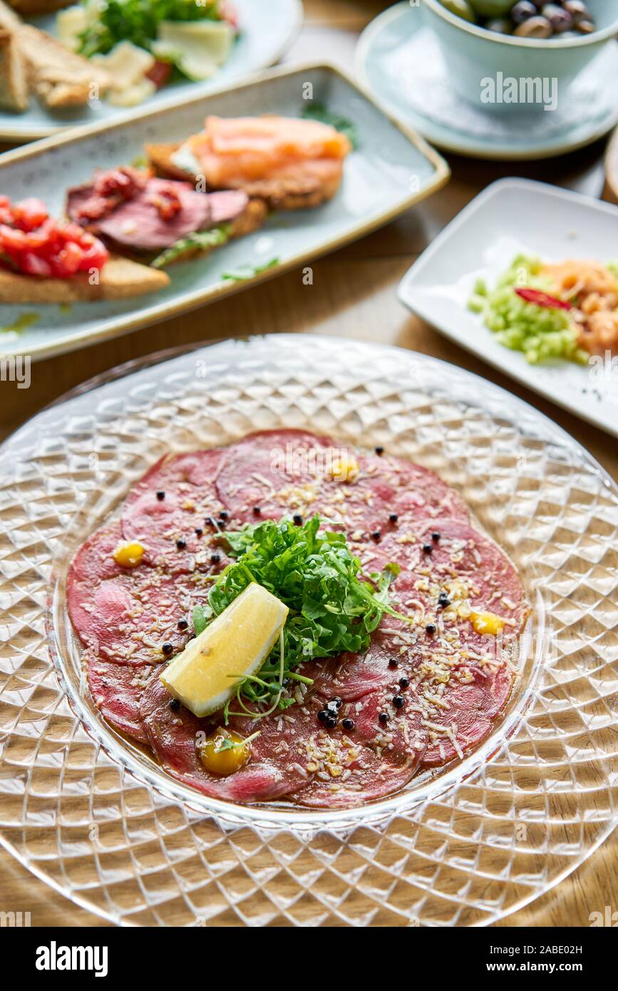 Beef carpaccio with balsamic caviar and Parmesan cheese. Various snacks ...