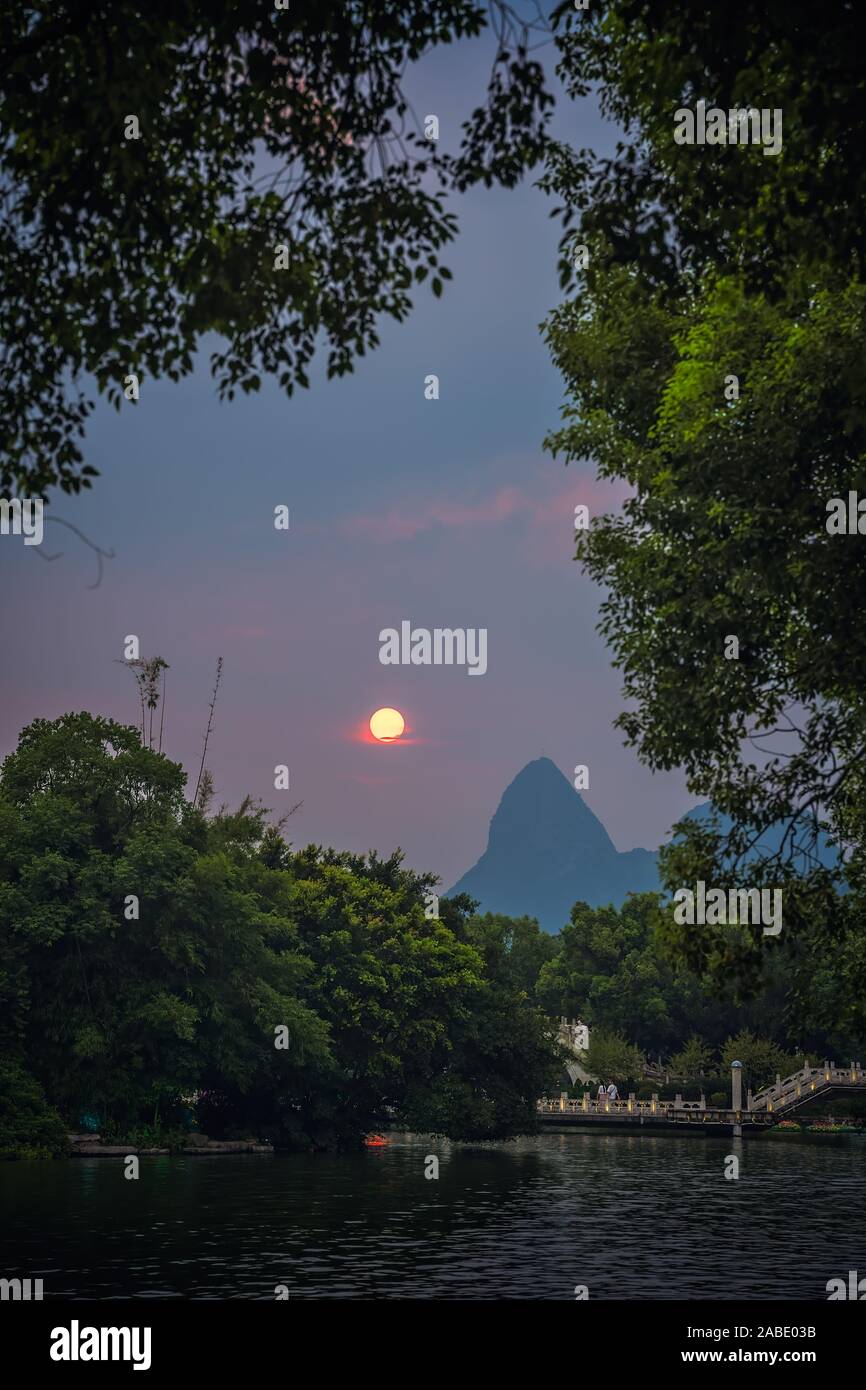 Sun setting over the Shan Lake in Guilin Stock Photo - Alamy