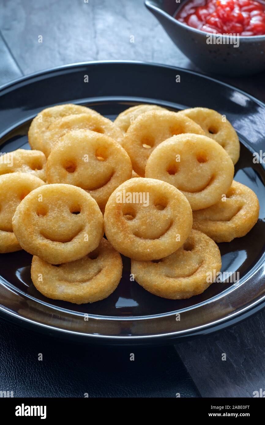 Happy French fried potato smiley faces with ketchup Stock Photo - Alamy