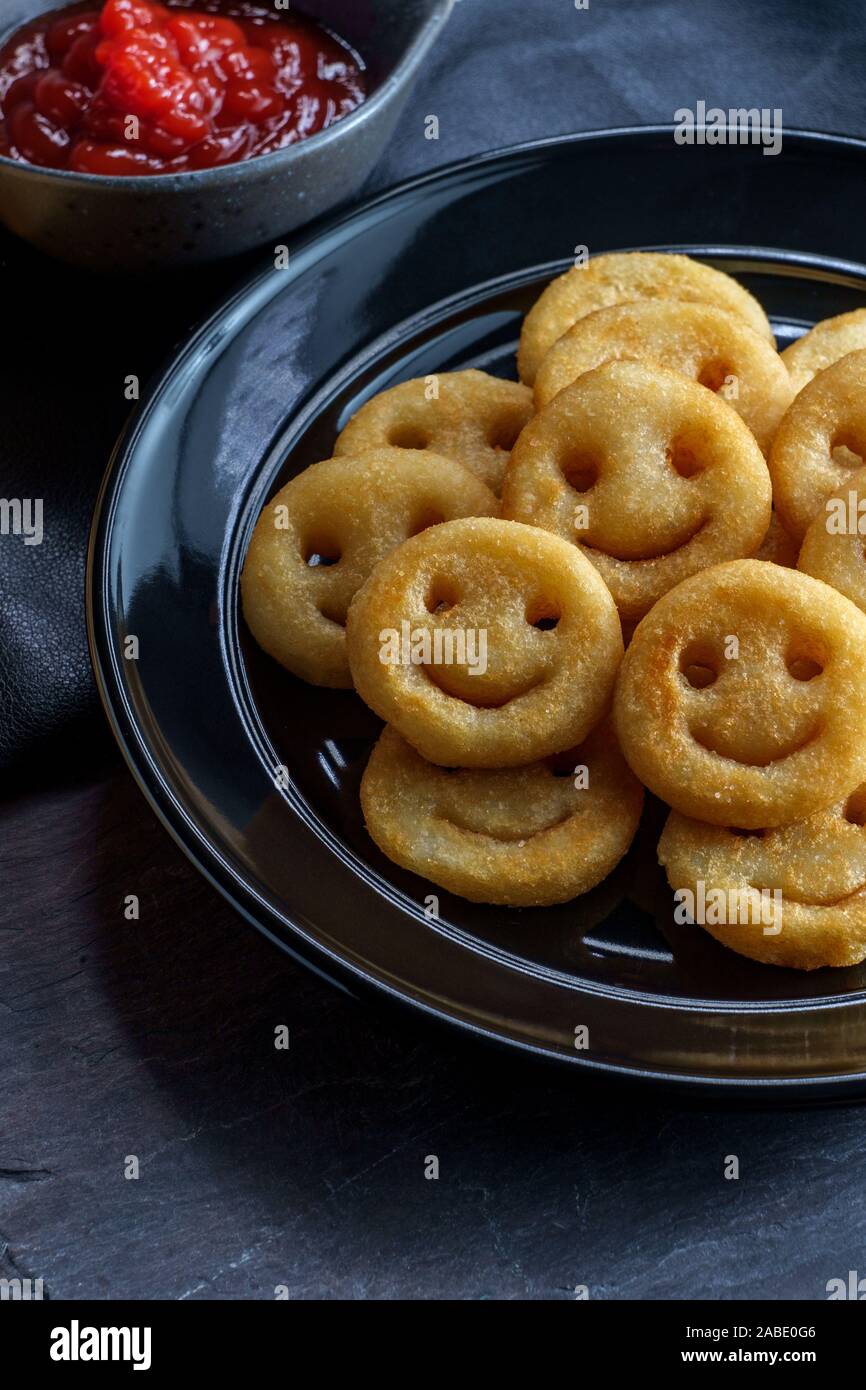 Happy French fried potato smiley faces with ketchup Stock Photo - Alamy