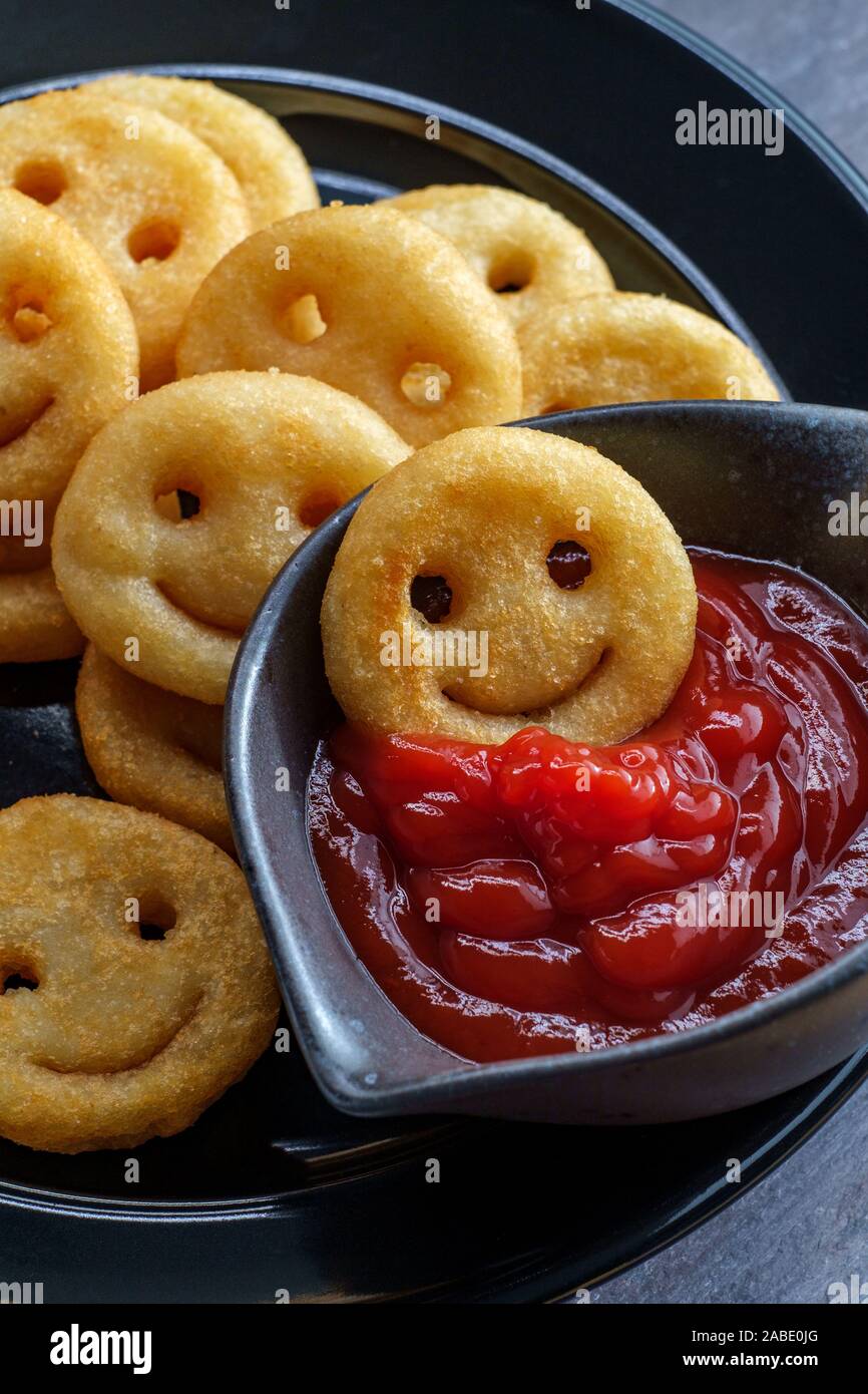 Happy French fried potato smiley faces with ketchup Stock Photo - Alamy