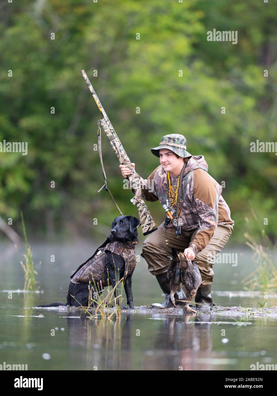 A Young Duck hunter and his hunting dog Stock Photo - Alamy