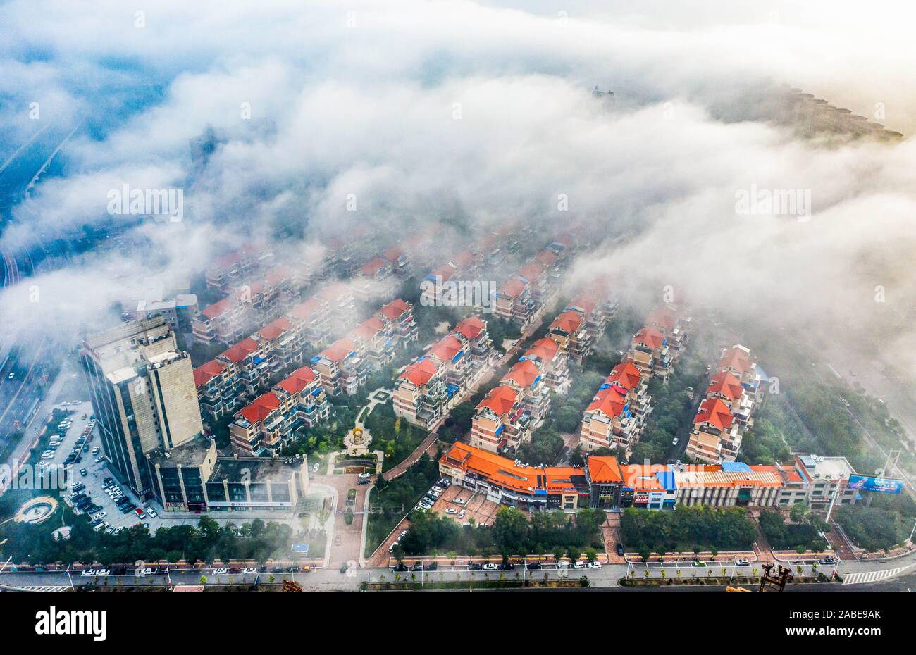 An aerial view of buildings in the downtown area standing in fog in ...