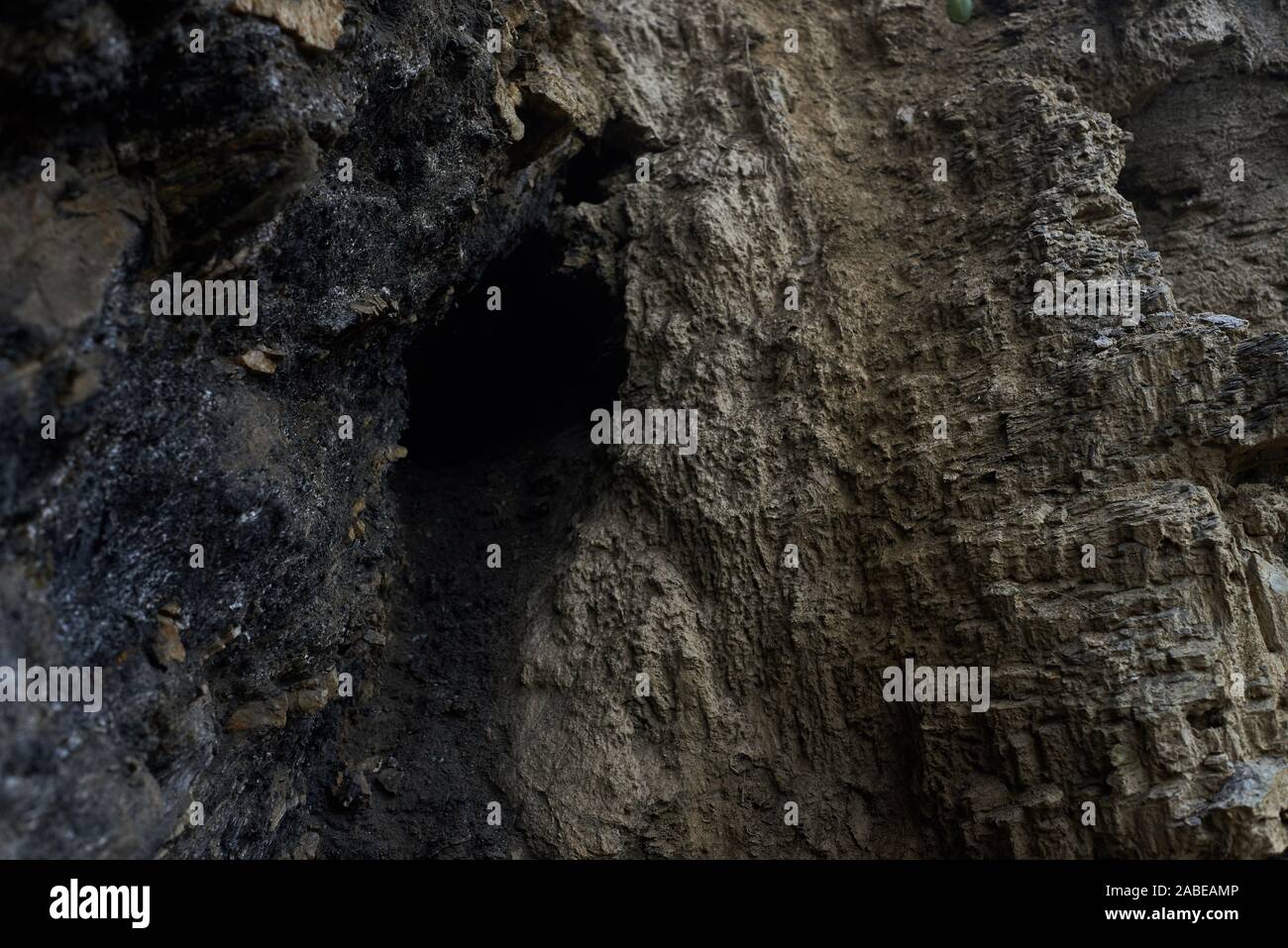 cave in a black rock mountain Stock Photo - Alamy