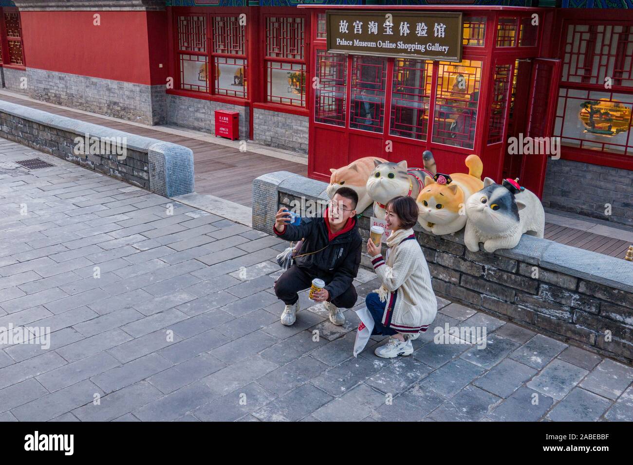 People take pictures with the giant cats put at the Shenwu Gate of the ...