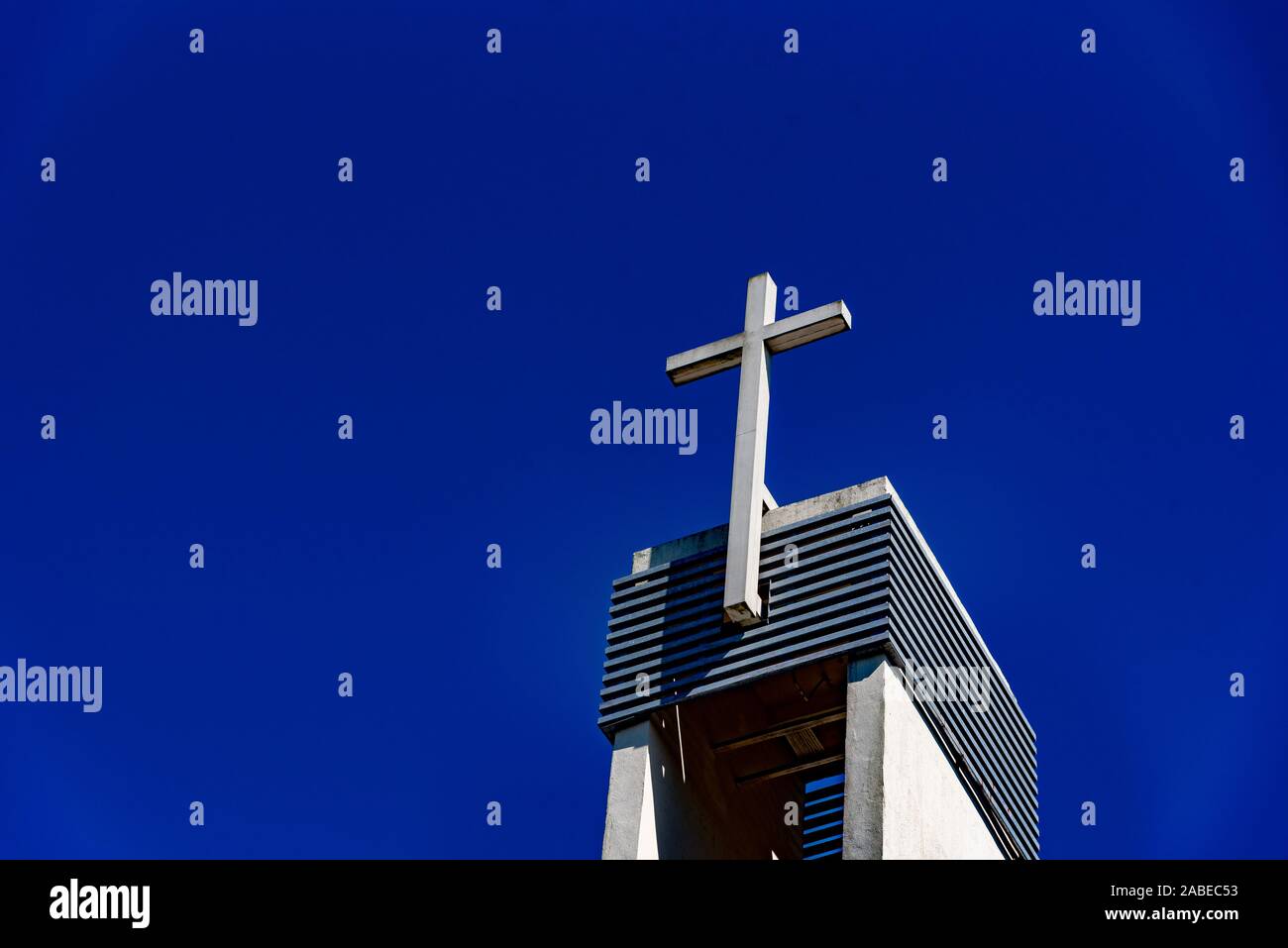 Catholic church tower and a cross on its top. religious temple in ...