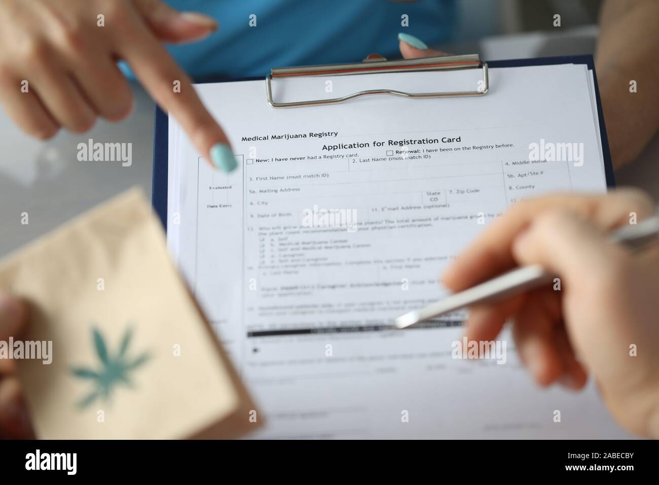 Patient filling application for registration card Stock Photo - Alamy