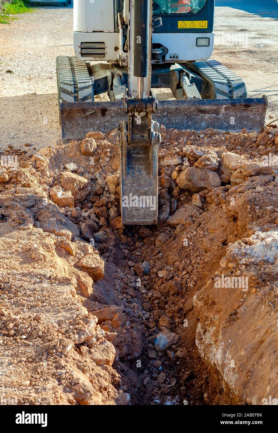 excavation with a narrow section to bury corrugated plastic cable ducts ...