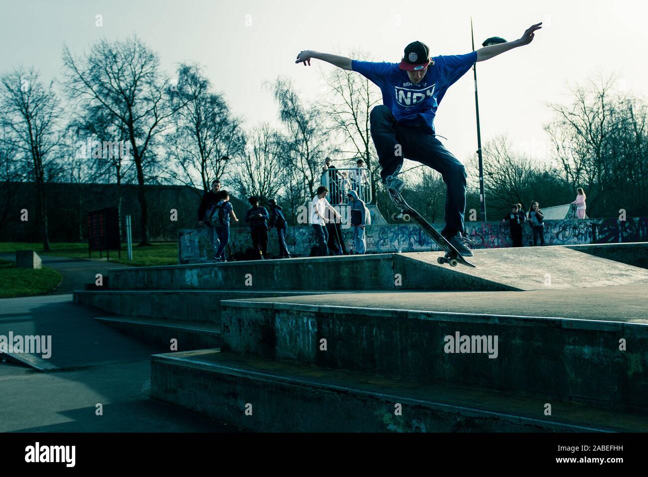 A group of professional skaters, skateboarders practicing ollieing off ...