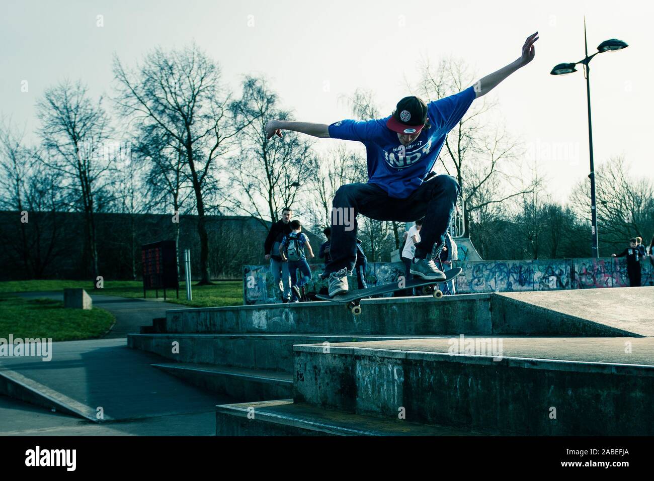 A group of professional skaters, skateboarders practicing ollieing off ...