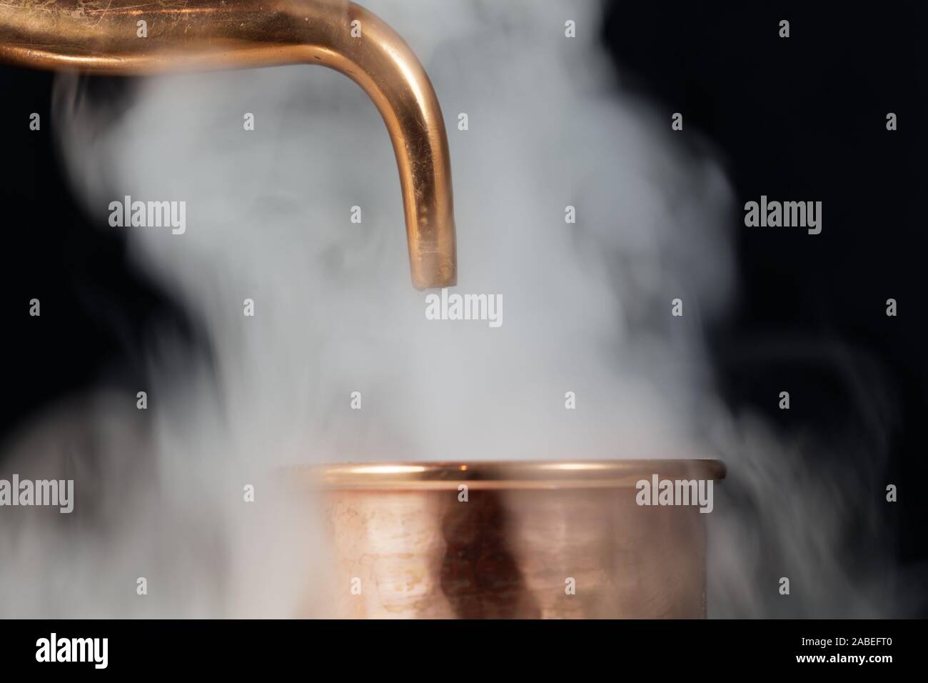 A copper pipe of a distillery with steam Stock Photo - Alamy
