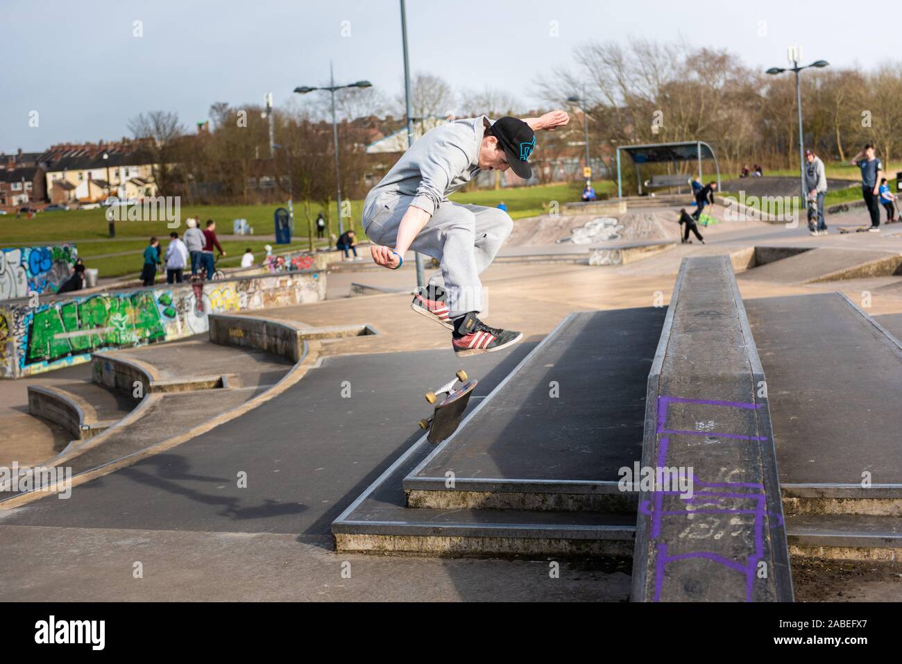 A group of professional skaters, skateboarders practicing ollieing off ...