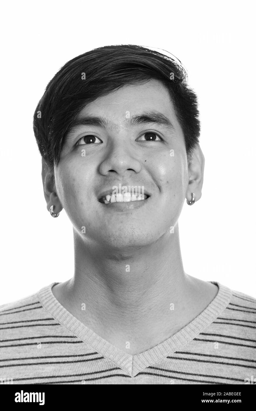 Face of young happy Asian man smiling while thinking Stock Photo - Alamy