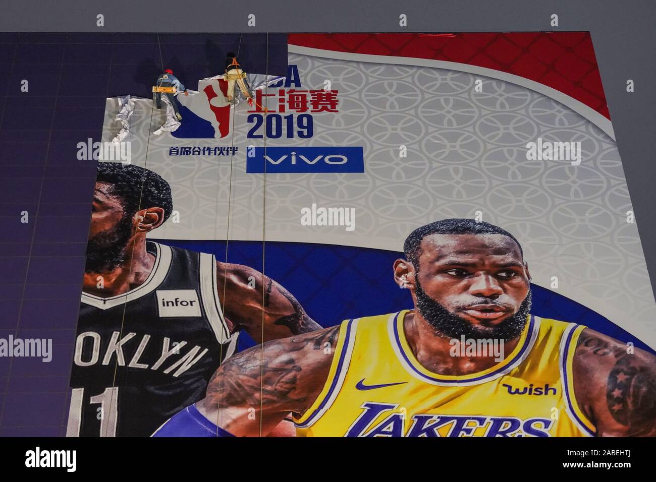 Construction workers dismentle a giant poster of NBA before 2019 NBA ...