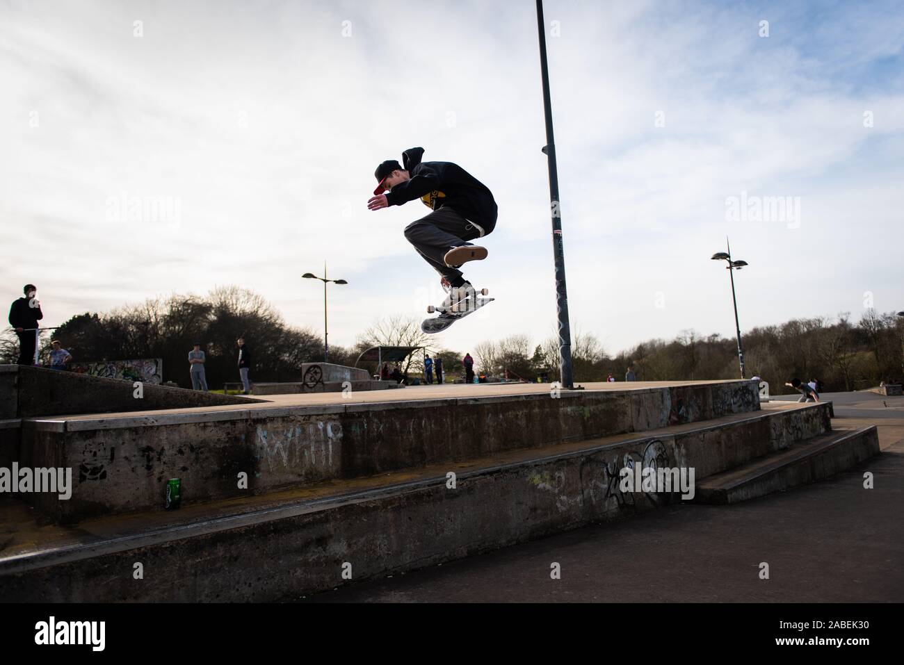 A group of professional skaters, skateboarders practicing ollieing off ...