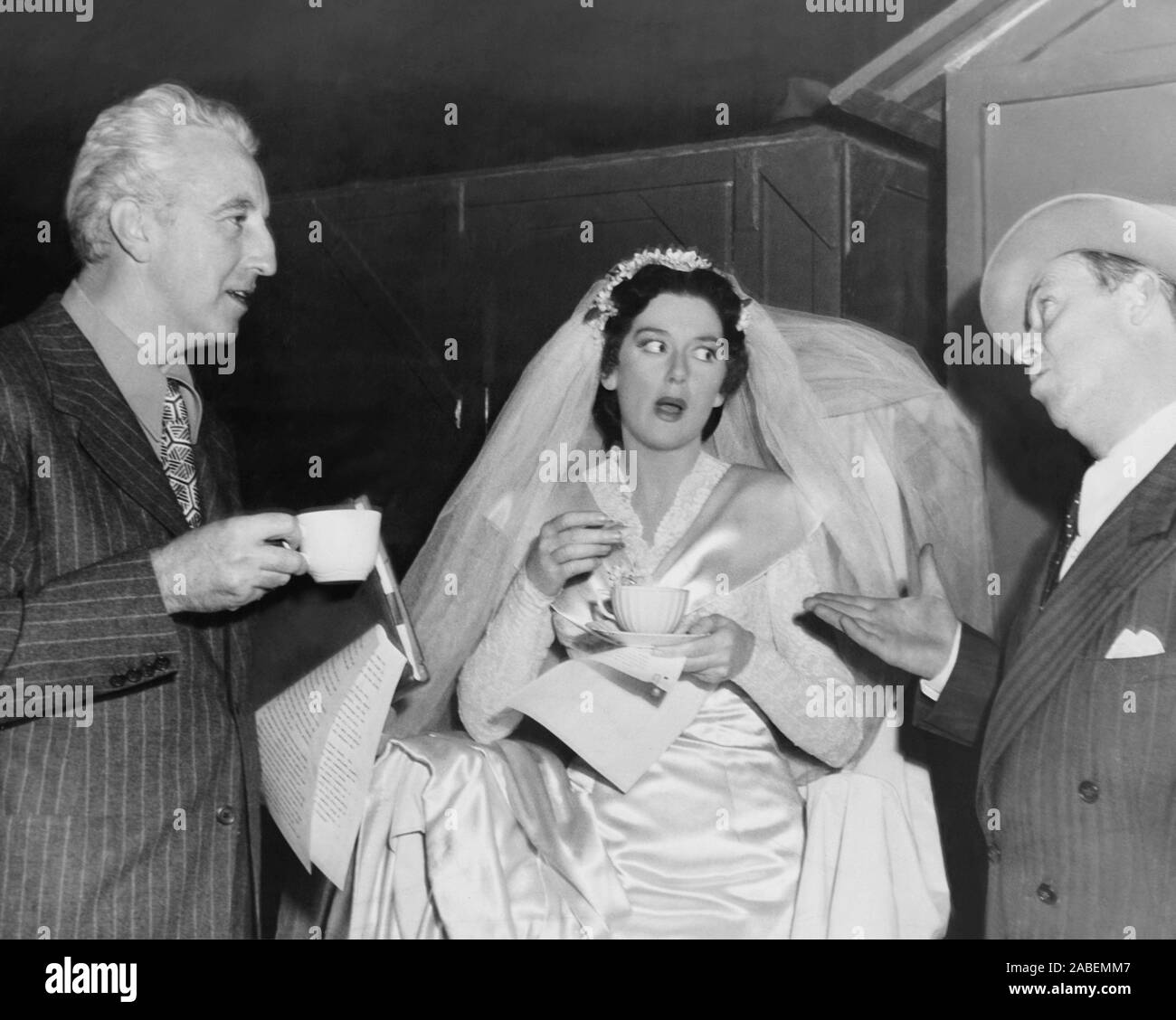SISTER KENNY, from left: director Dudley Nichols, Rosalind Russell ...