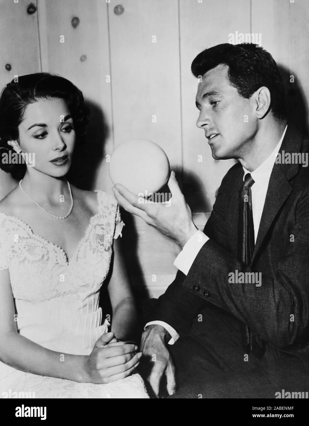 SOMETHING OF VALUE, from left: Dana Wynter, Rock Hudson examining an ...