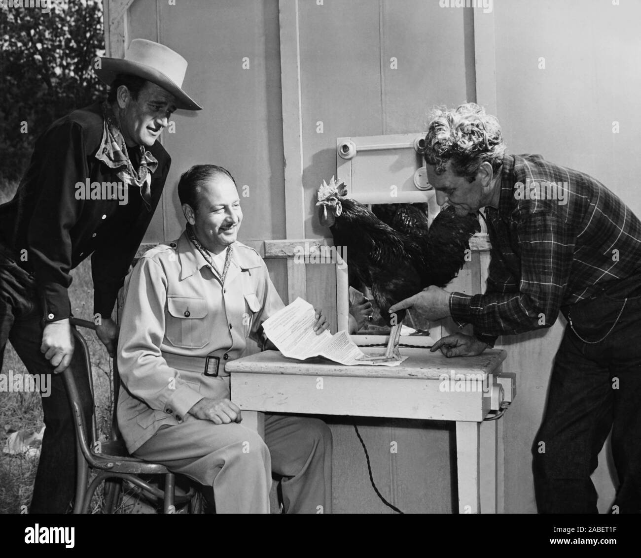 TALL IN THE SADDLE, from left: John Wayne and director Edwin L. Marin ...
