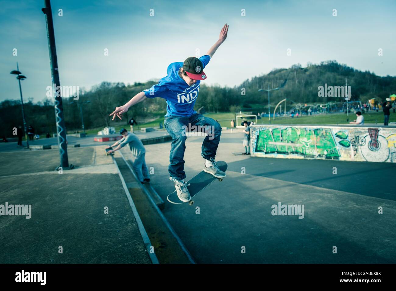 A group of professional skaters, skateboarders practicing ollieing off ...
