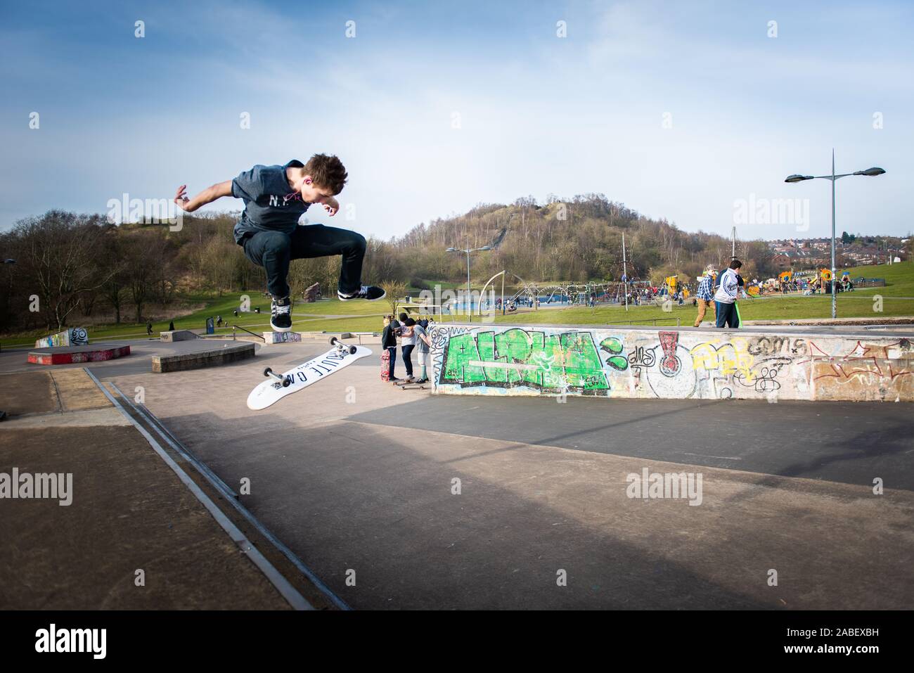 A group of professional skaters, skateboarders practicing ollieing off ...
