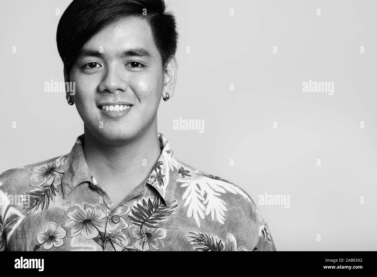 Face of young happy Asian tourist man smiling Stock Photo - Alamy