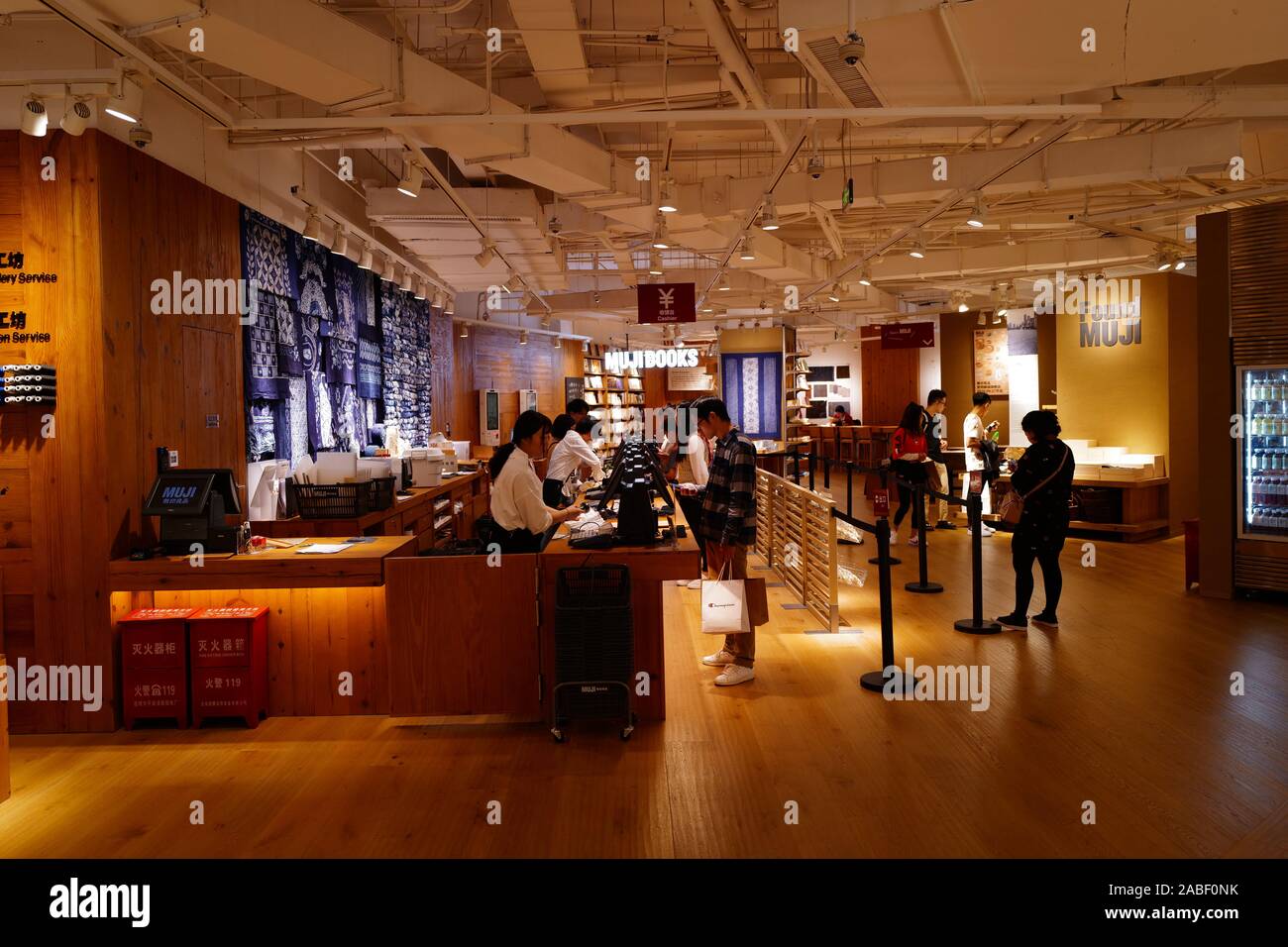 People check out at the newly opened Muji flagship store in Kunming ...