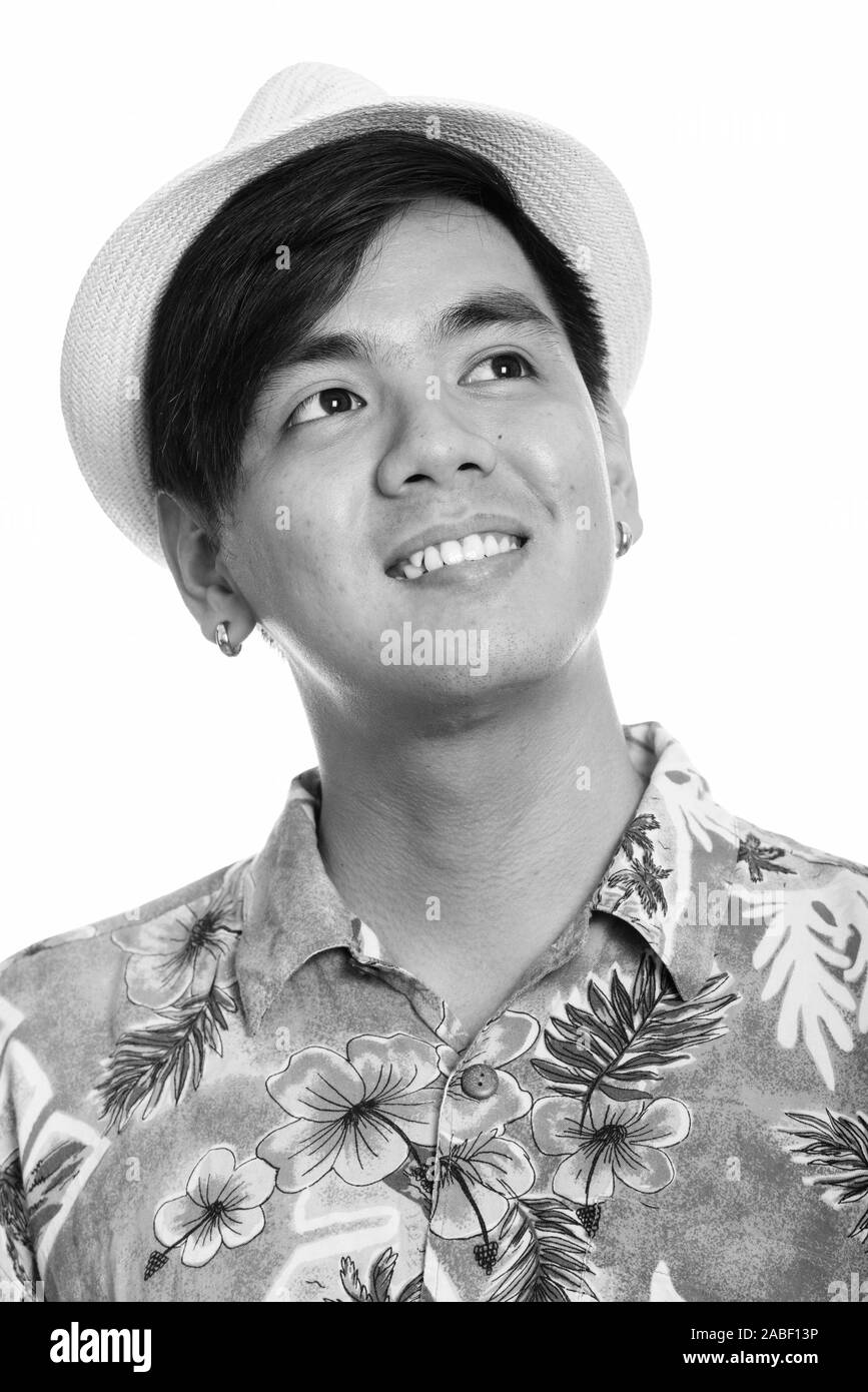 Face of young happy Asian tourist man smiling while thinking Stock ...