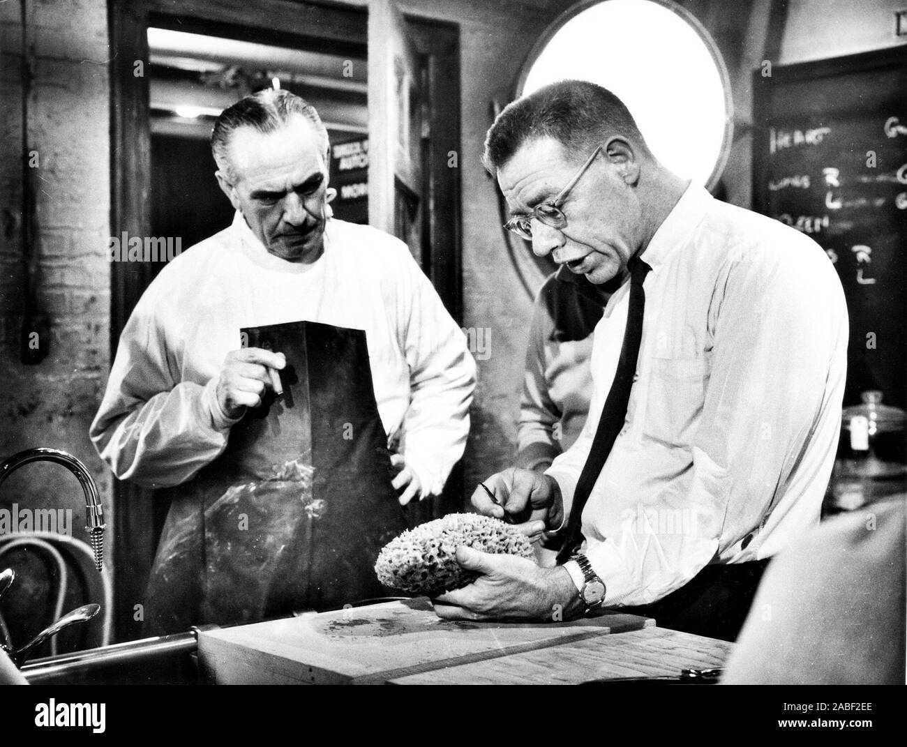 THE YOUNG DOCTORS, Fredric March, left, training with technical advisor ...