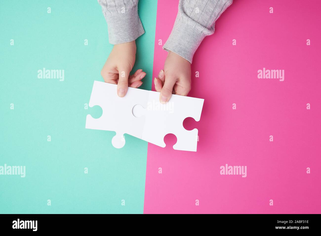 two empty paper white pieces of puzzles in female hands, puzzle ...