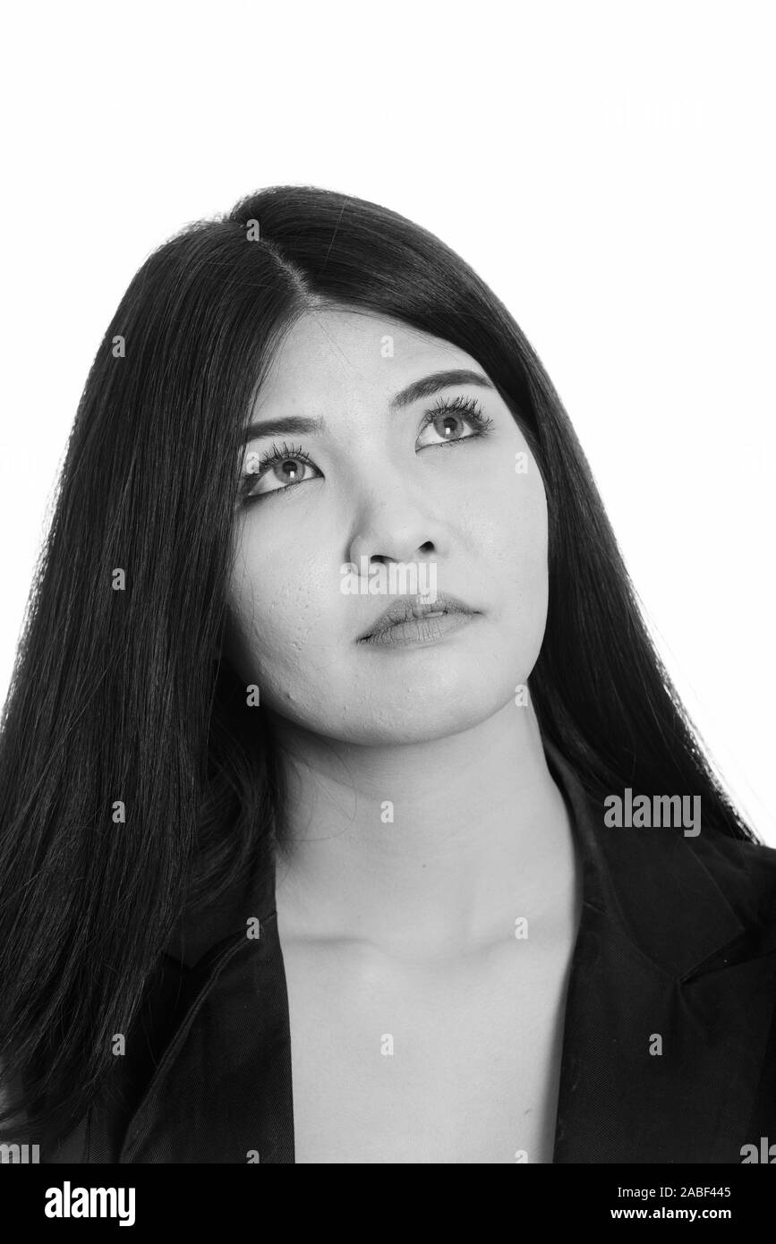 Face of young Asian woman looking up while thinking Stock Photo - Alamy