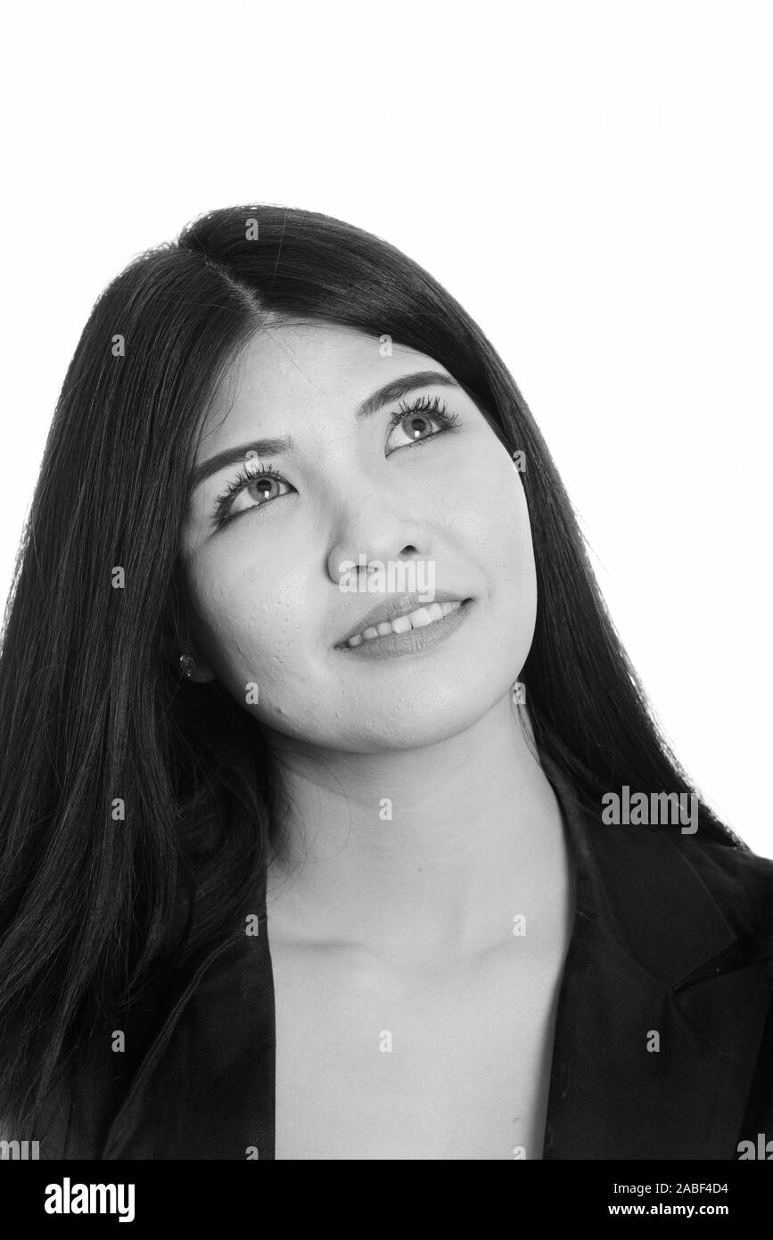 Face of young happy Asian woman smiling while thinking Stock Photo - Alamy