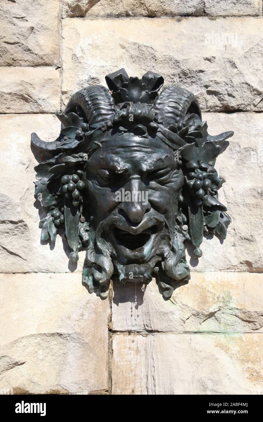 Occult Horned, Goat Man Face Statue Carving mounted on a tan, cement ...