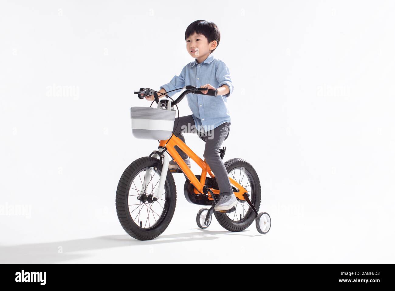 Happy little boy riding bike Stock Photo - Alamy