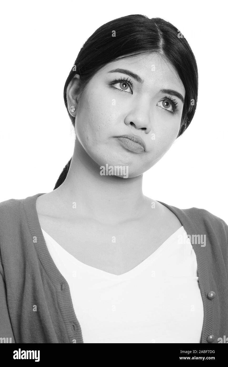 Face of young Asian woman thinking and looking up Stock Photo - Alamy