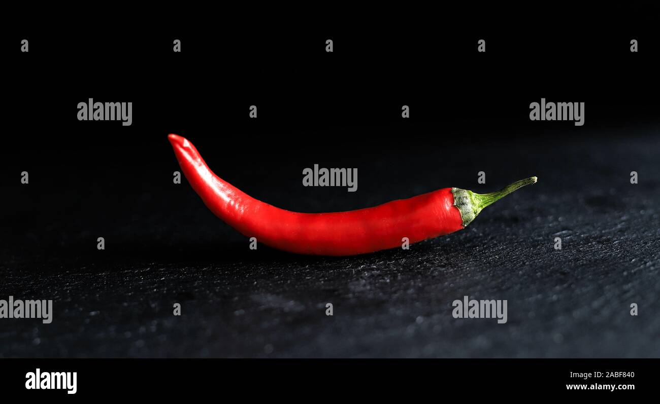 Top view of red chilli pepper on dark background Stock Photo - Alamy