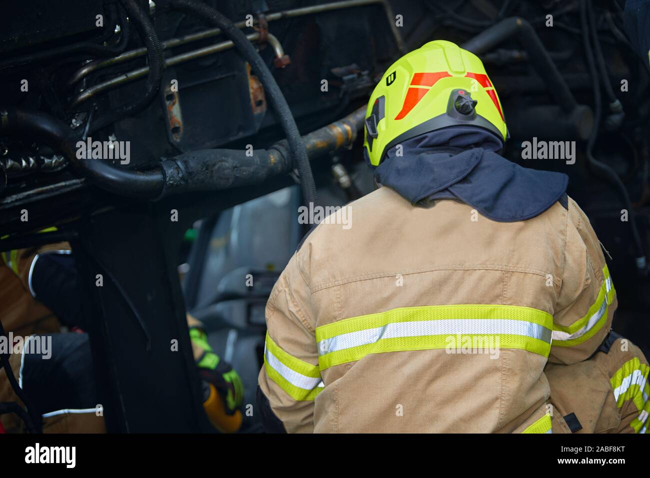 Firefighter in action at a heavy car accident scene Stock Photo - Alamy