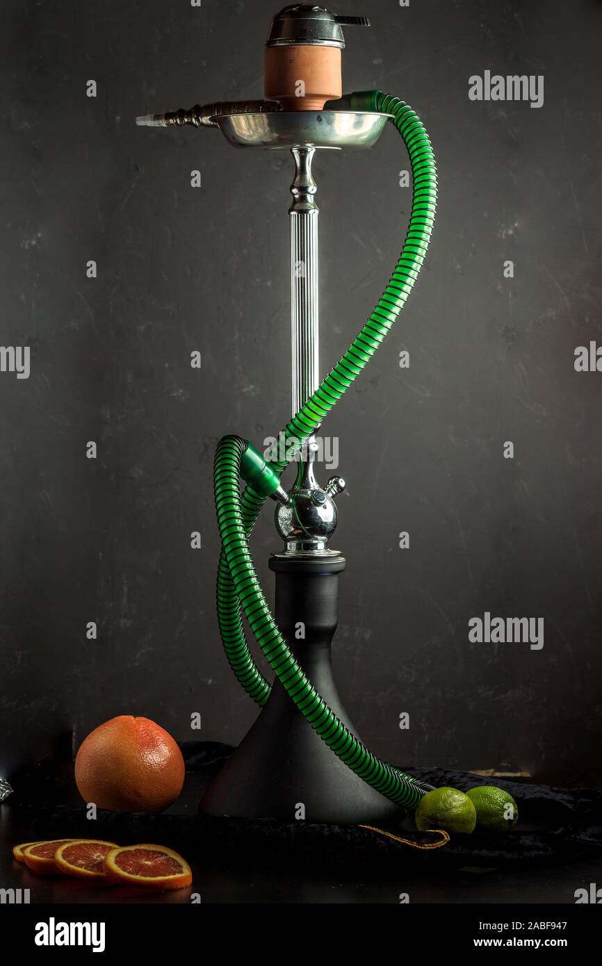 hookah stand with green pipe in black background Stock Photo - Alamy