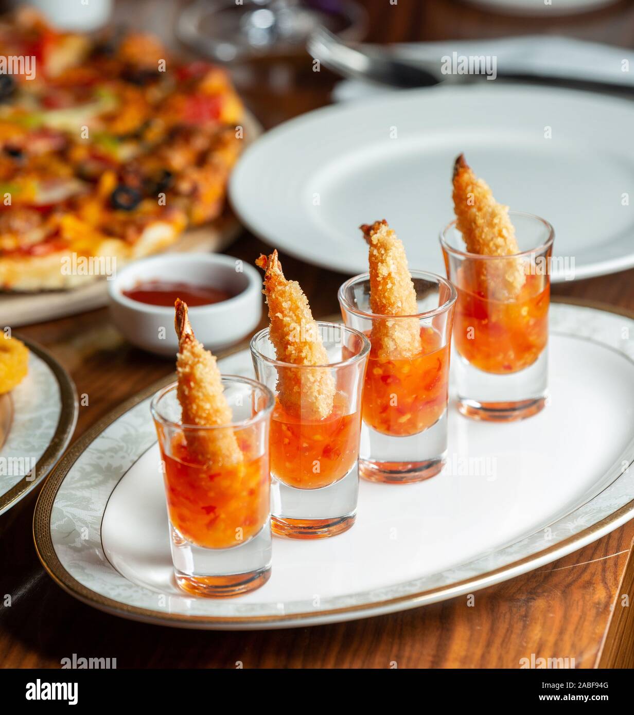 crispy fried prawns served in shot glasses with sweet chili sauce Stock ...
