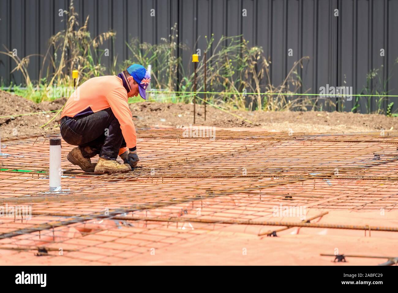 Australian builder performing steel fixing operations for a new ...