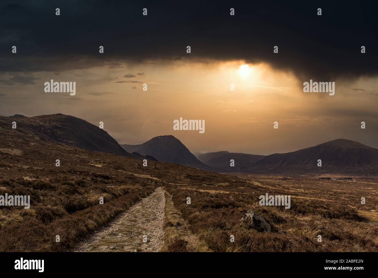 A dark and moody sunset in the Glencoe valley in the Scottish highlands ...