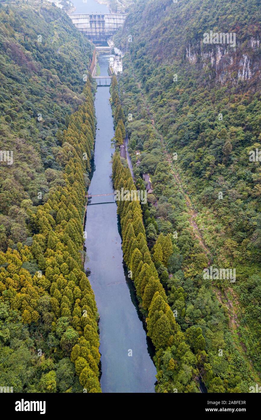 An aerial view of a bridge linking two sides of a river which goes ...