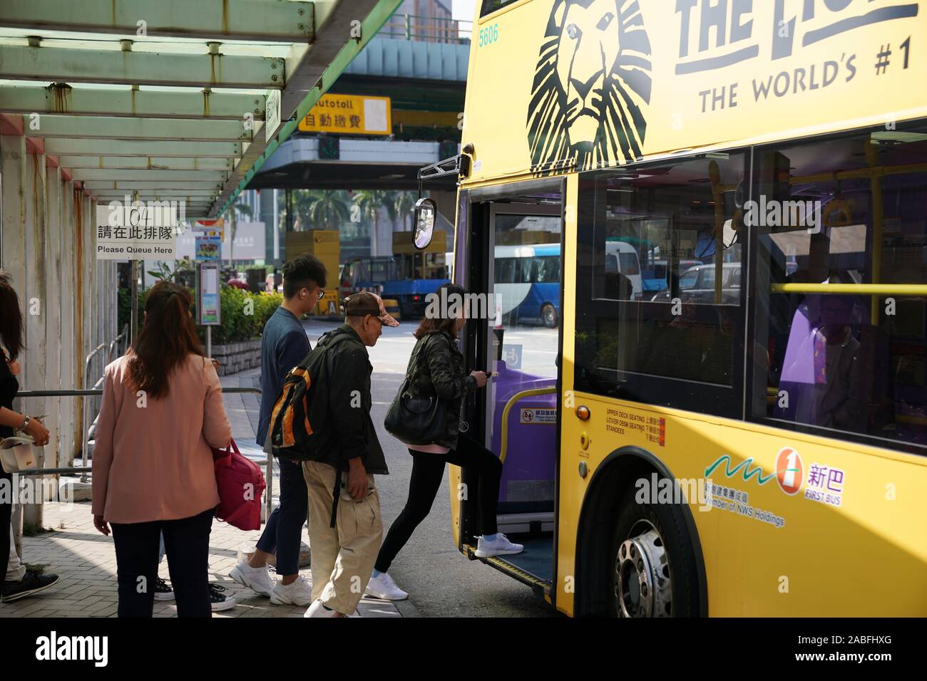 Hong Kong. 27th Nov, 2019. Citizens line up at a bus stop of cross ...