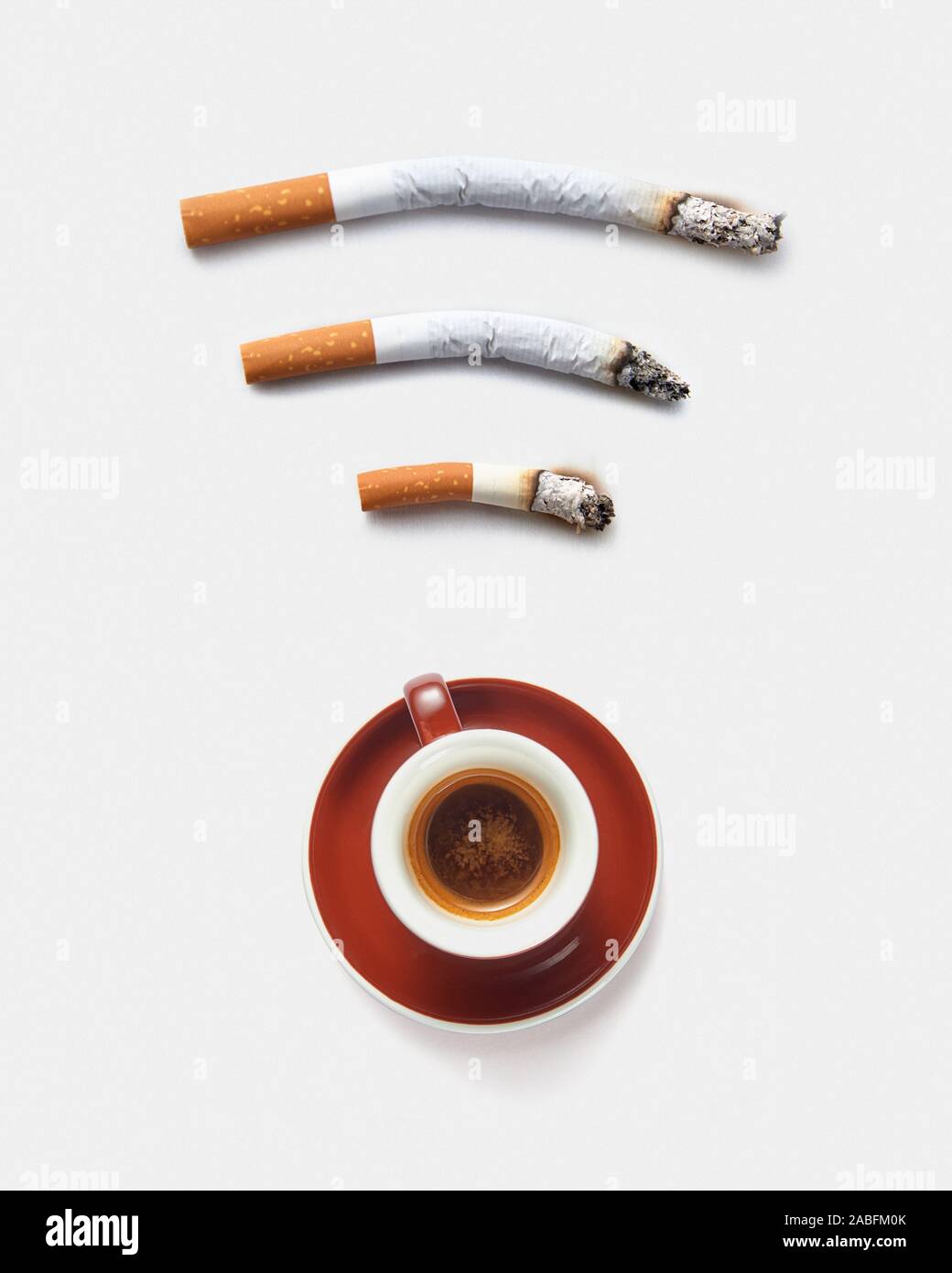Three roach cigaretts around a cup of coffee as a wireless simbol on a ...